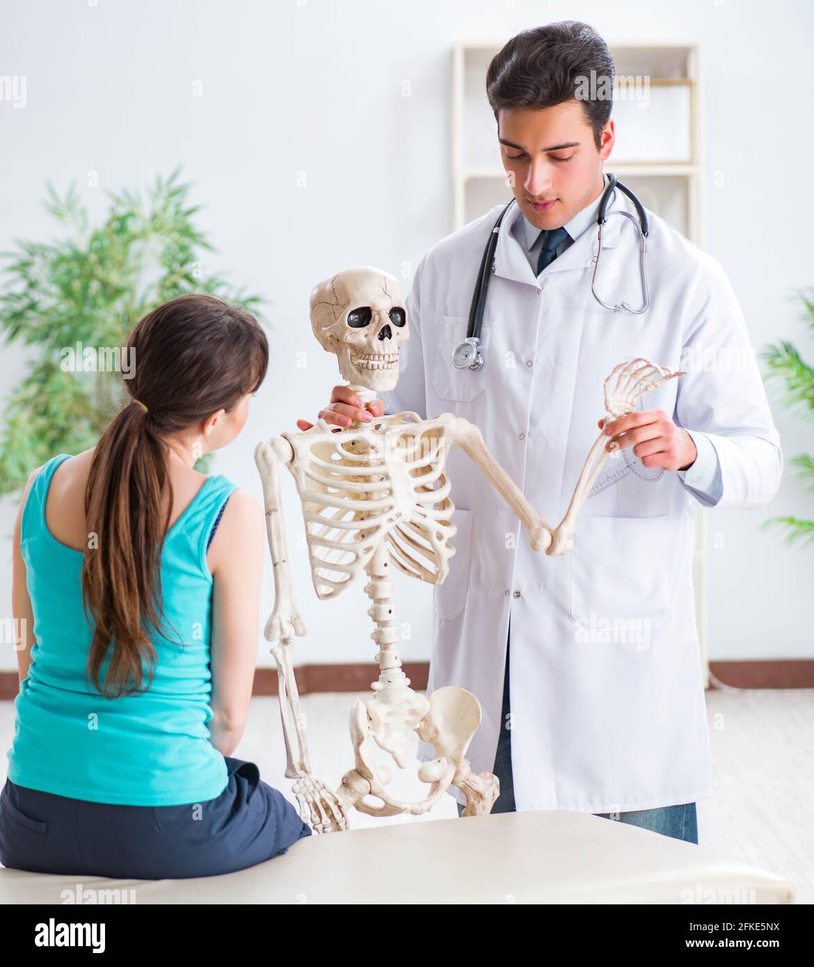 The doctor showing type of injury on skeleton to patient Stock Photo ...
