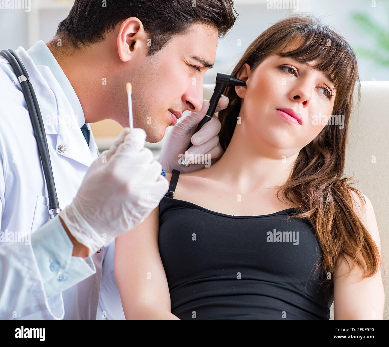 The doctor checking patients ear during medical examination Stock Photo ...