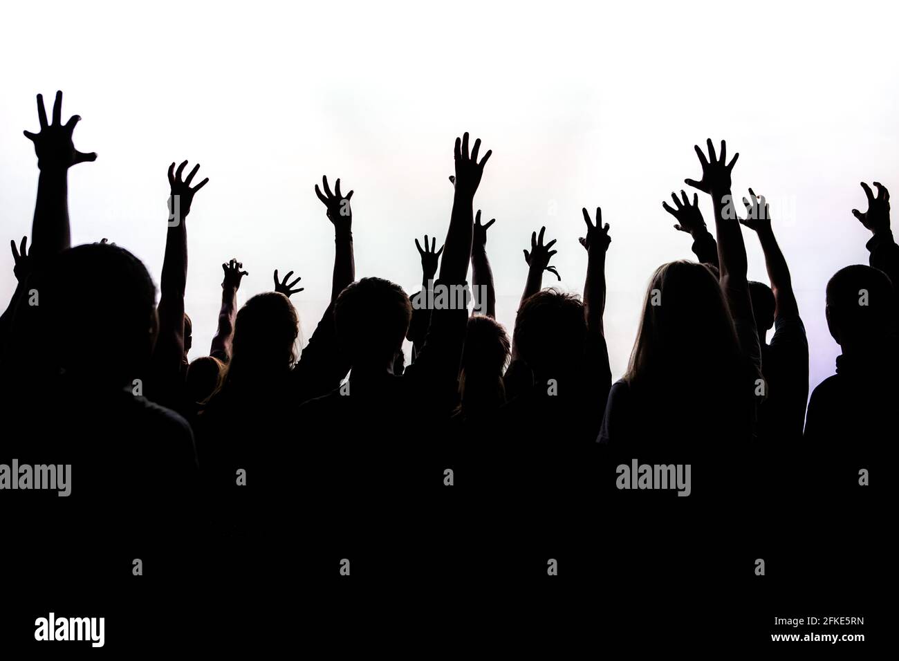 Young people reaching silhouette Stock Photo - Alamy
