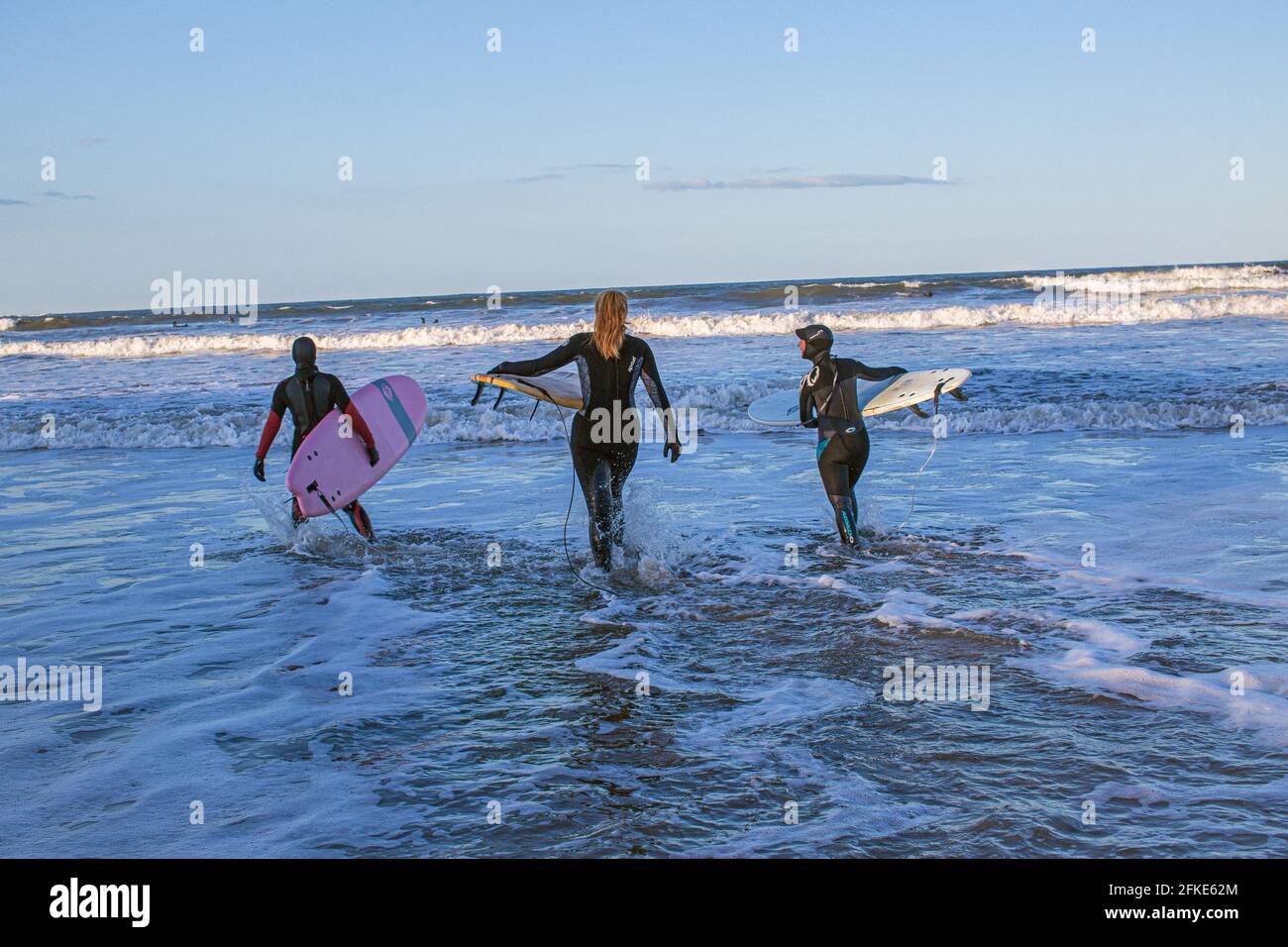 Young local woman surfing in the North sea at Seaton in Hartlepool ...
