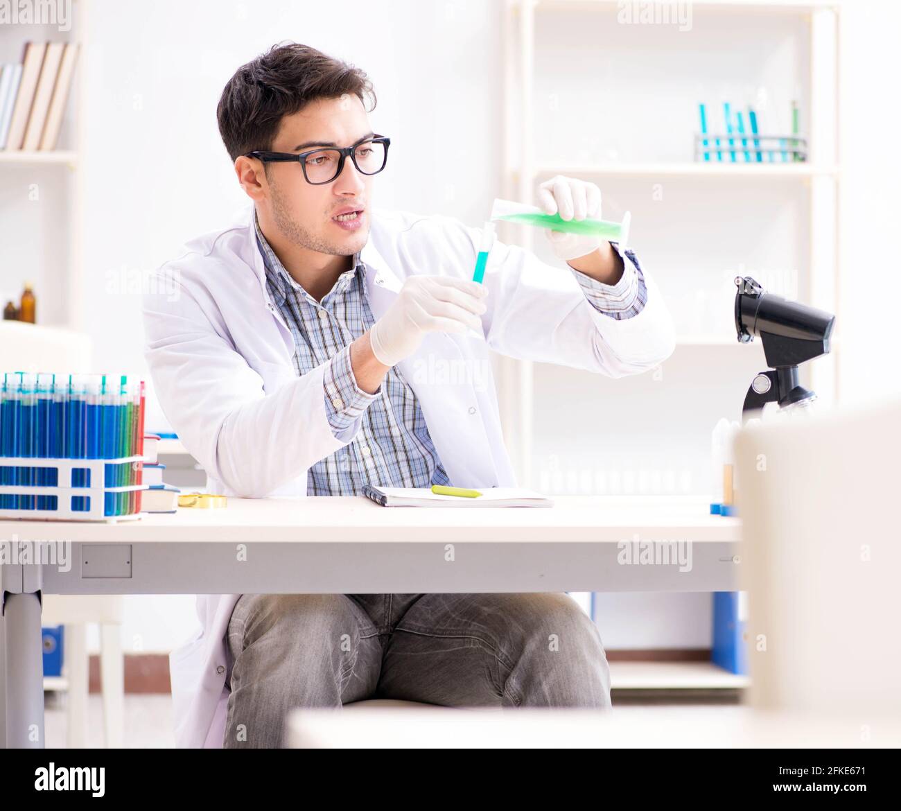 Chemistry student doing chemical experiments at classroom activity ...