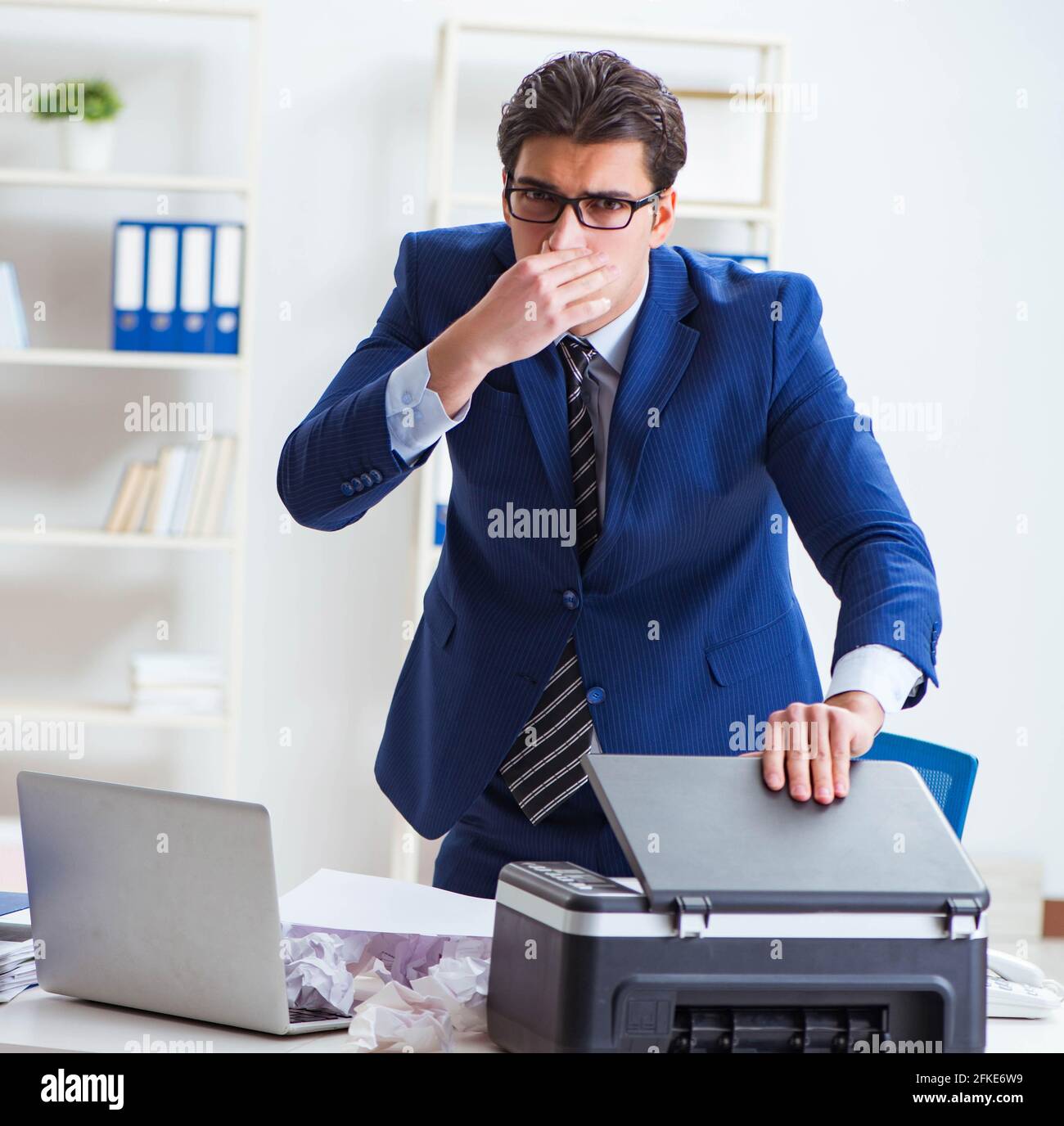 The businessman angry at copying machine jamming papers Stock Photo - Alamy