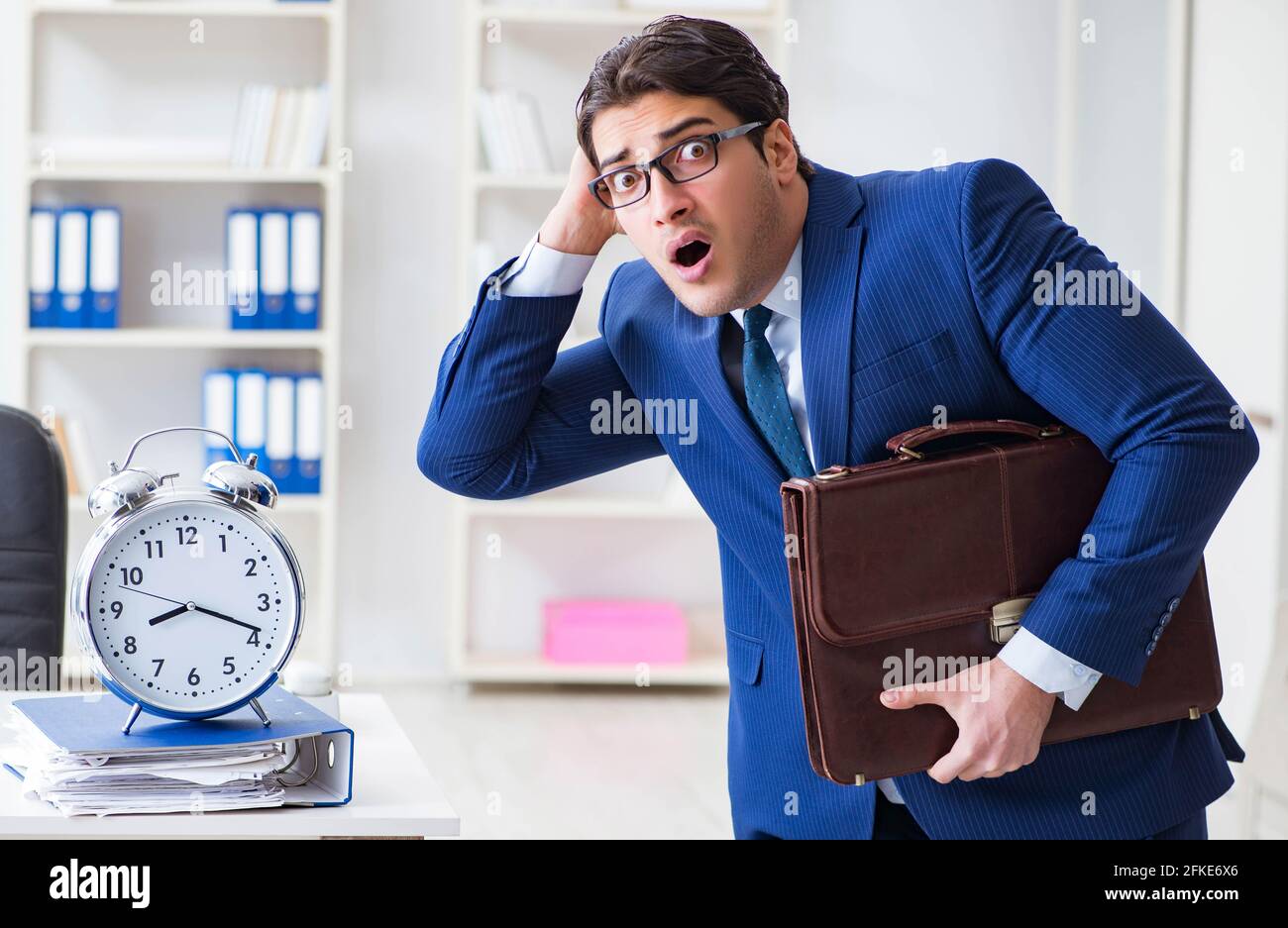 The businessman in bad time management concept Stock Photo - Alamy