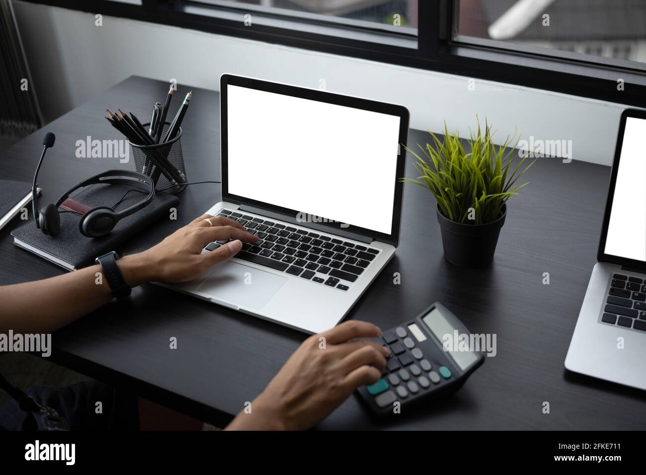 Close up view of female accountant using calculator and working with ...