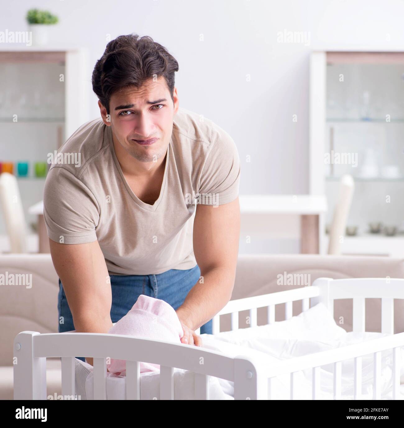 The young father dad frustrated at crying baby Stock Photo - Alamy