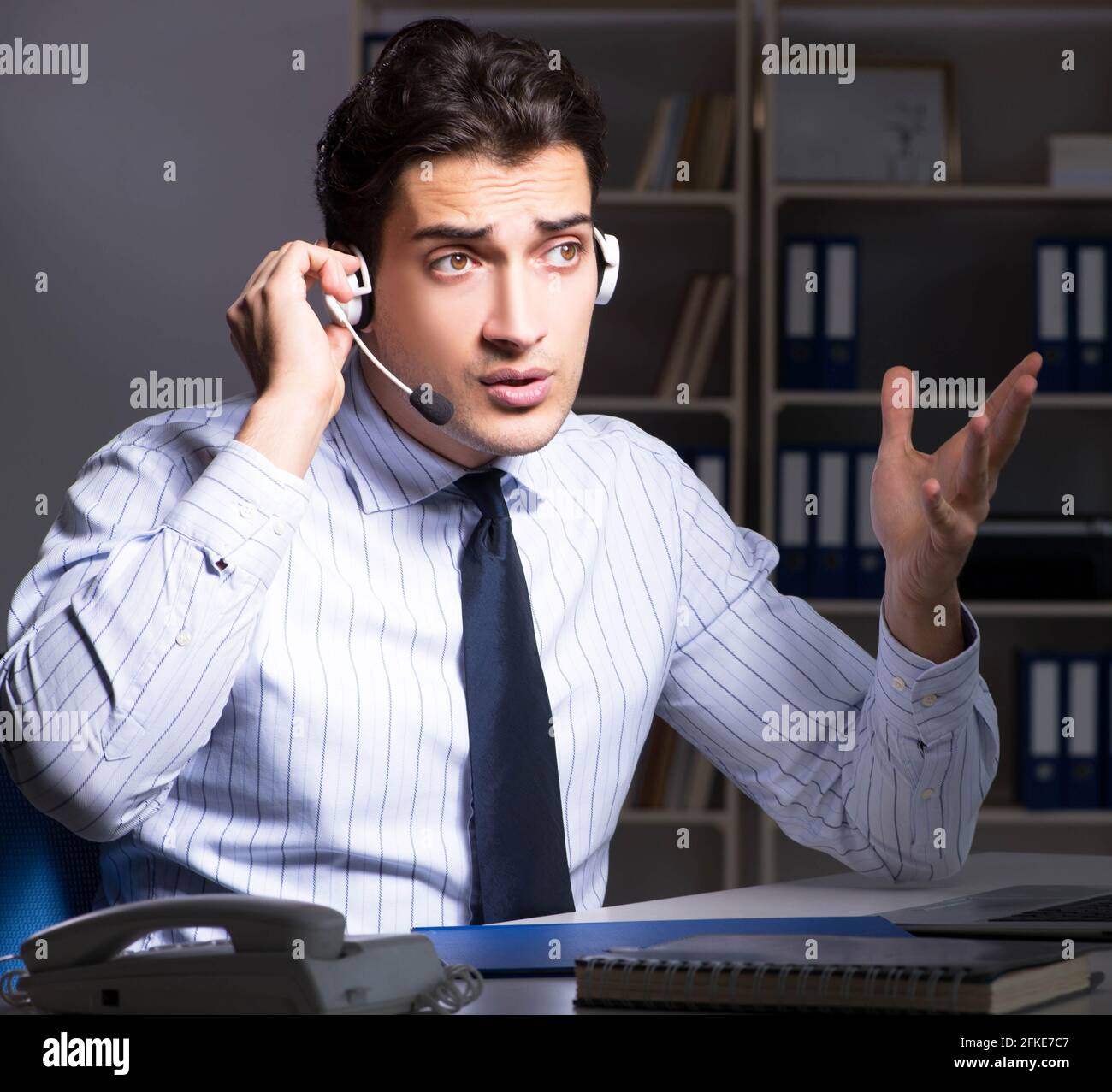 The tired and exhausted helpdesk operator during night shift Stock ...