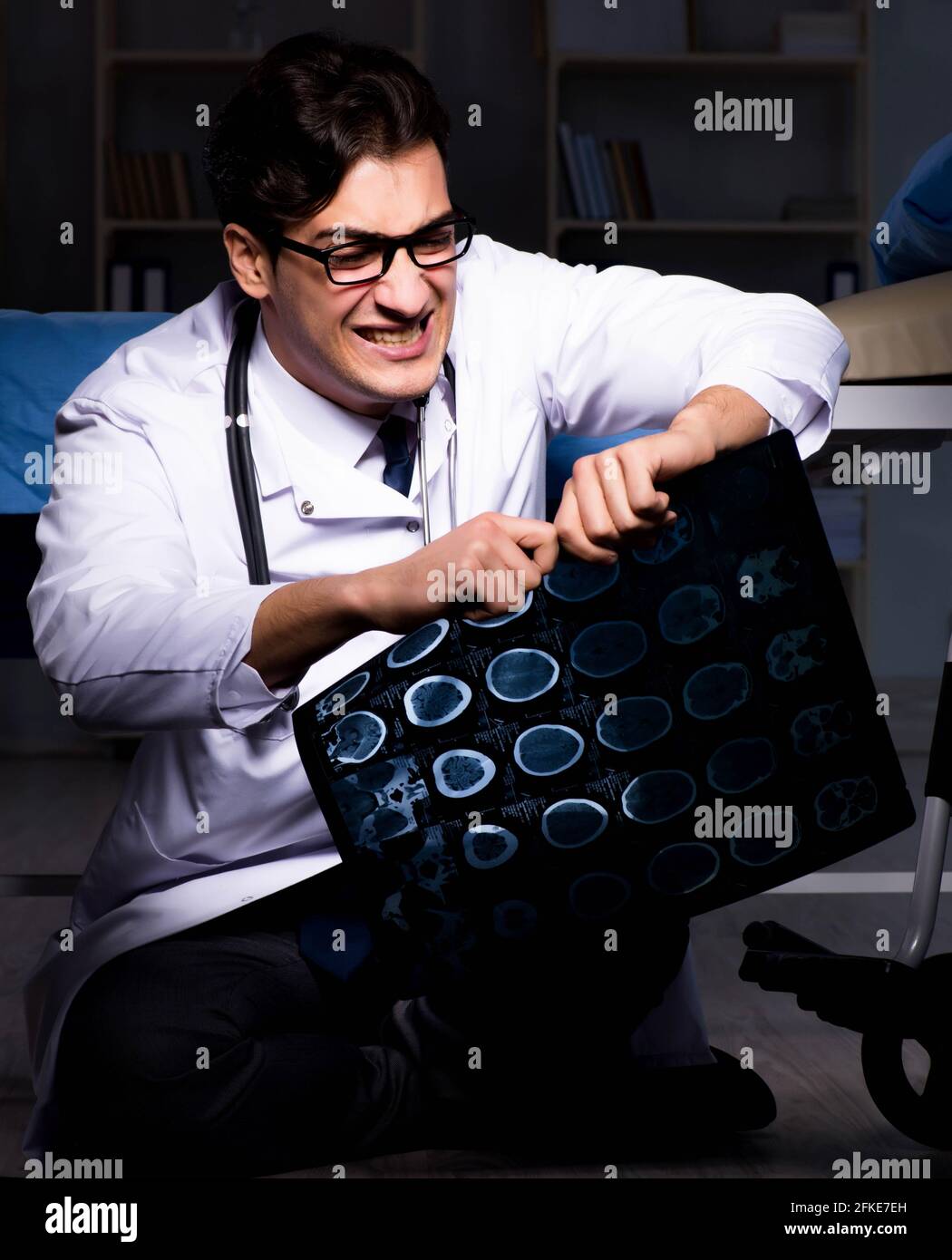 The doctor working night shift in hospital after long hours Stock Photo ...