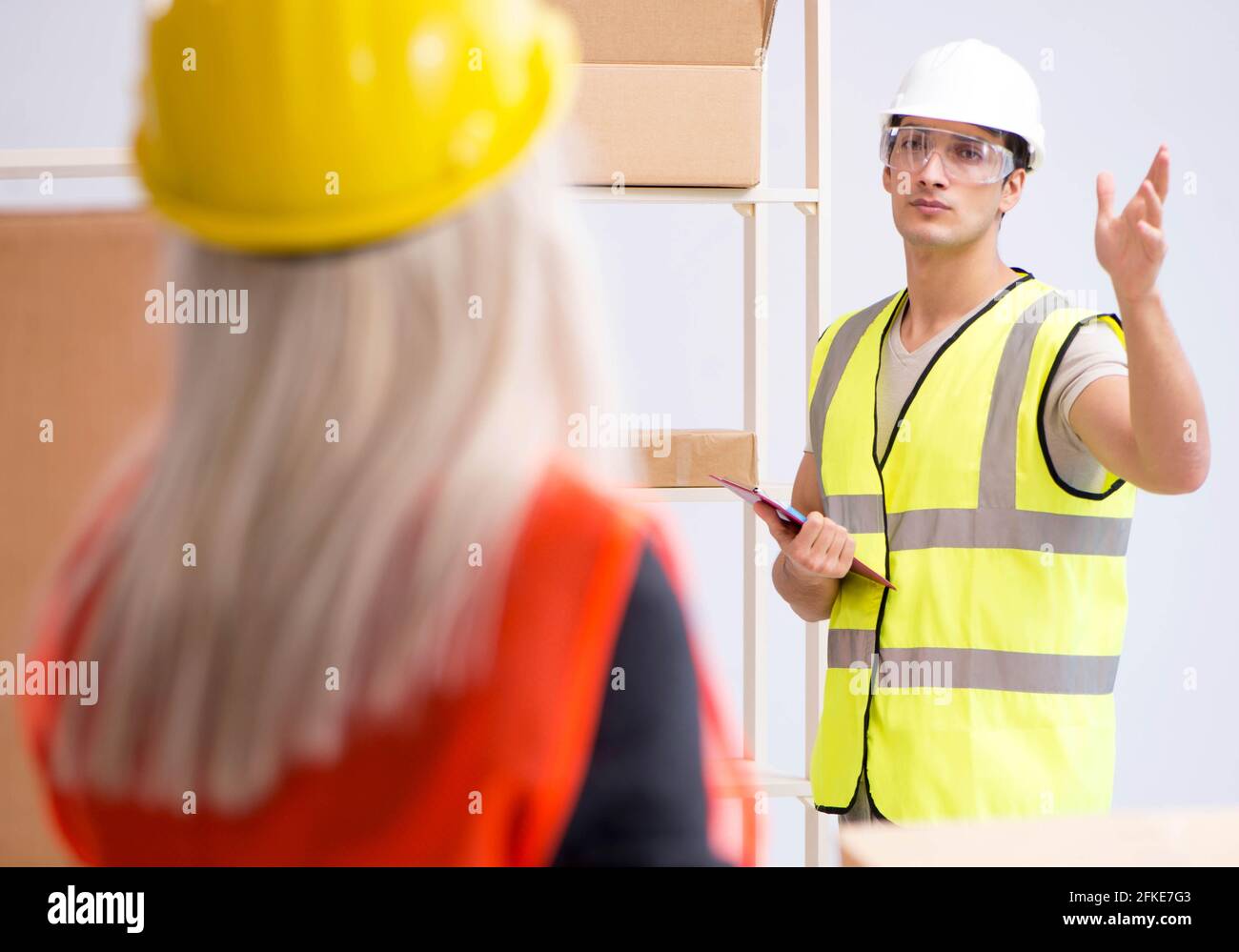 The delivery contractor delivering boxes to office Stock Photo - Alamy
