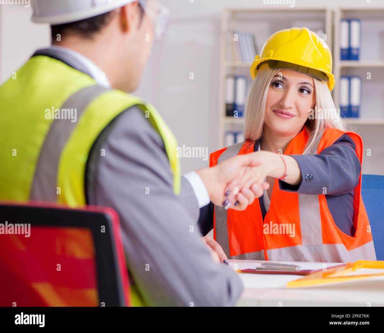 Construction workers having discussion in office before starting ...