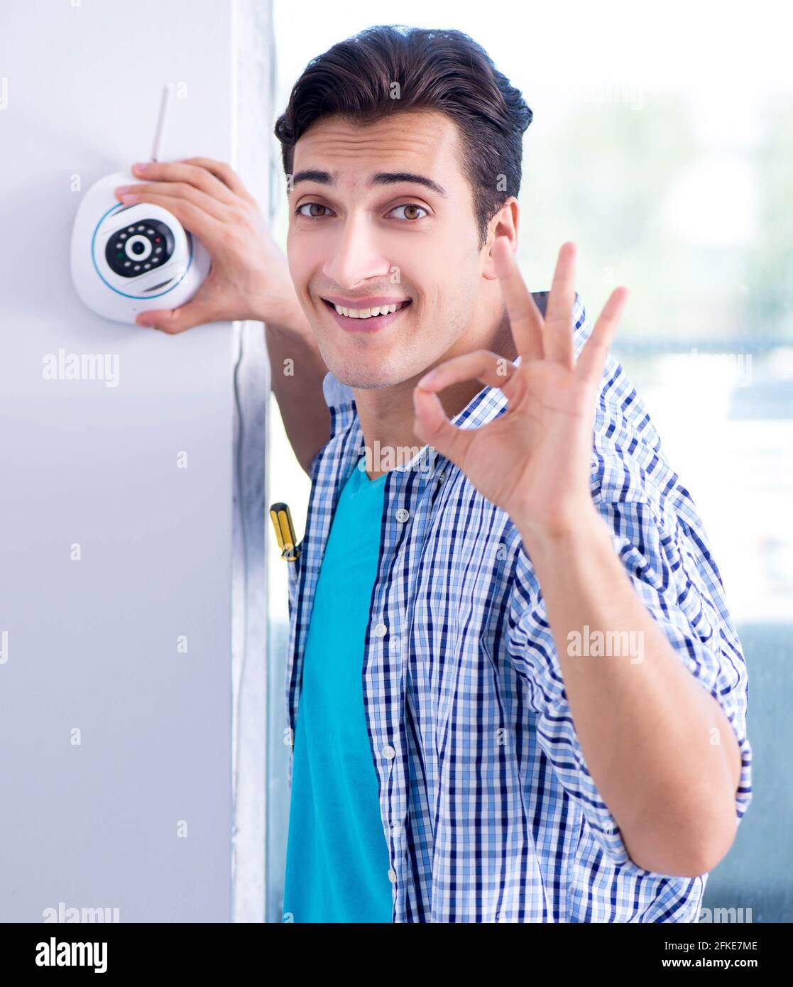 The man installing surveillance cctv cameras at home Stock Photo - Alamy