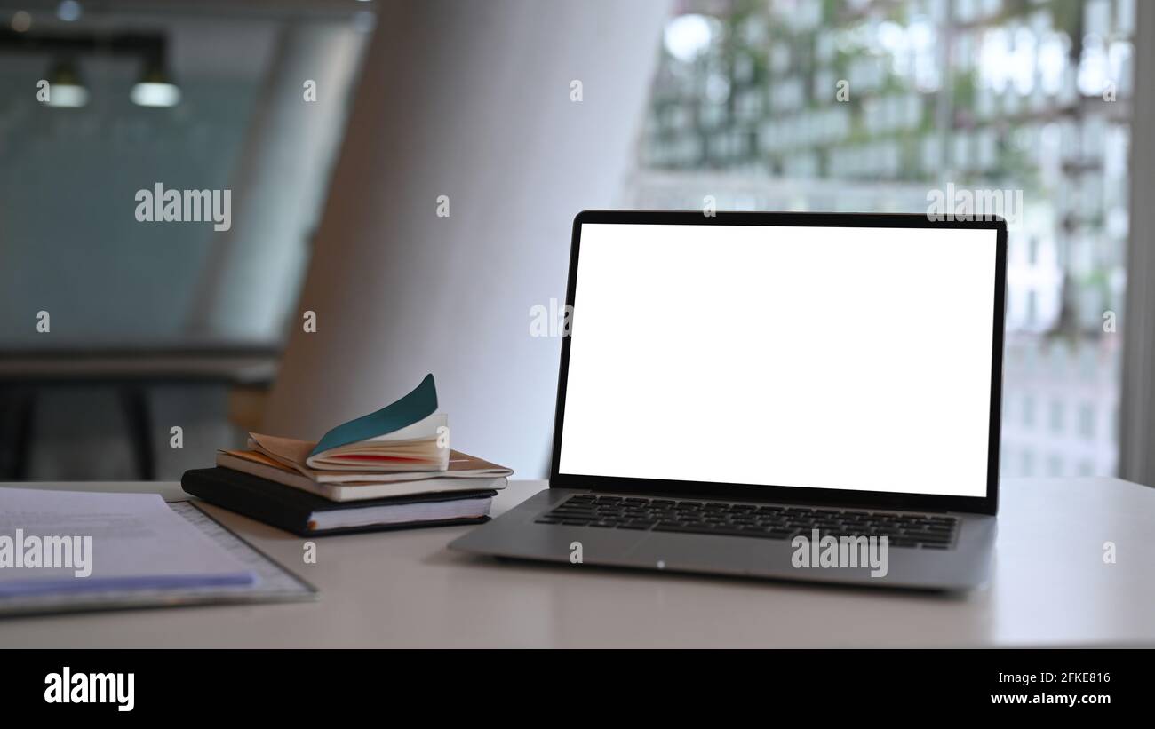 Close up view of mock up computer laptop with empty screen and books on ...