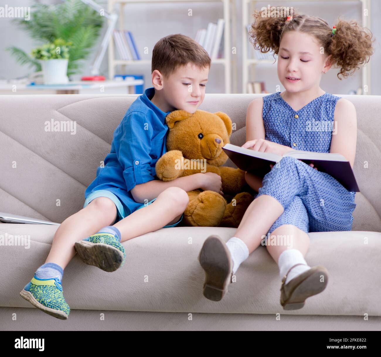 The two kids reading books at home Stock Photo - Alamy