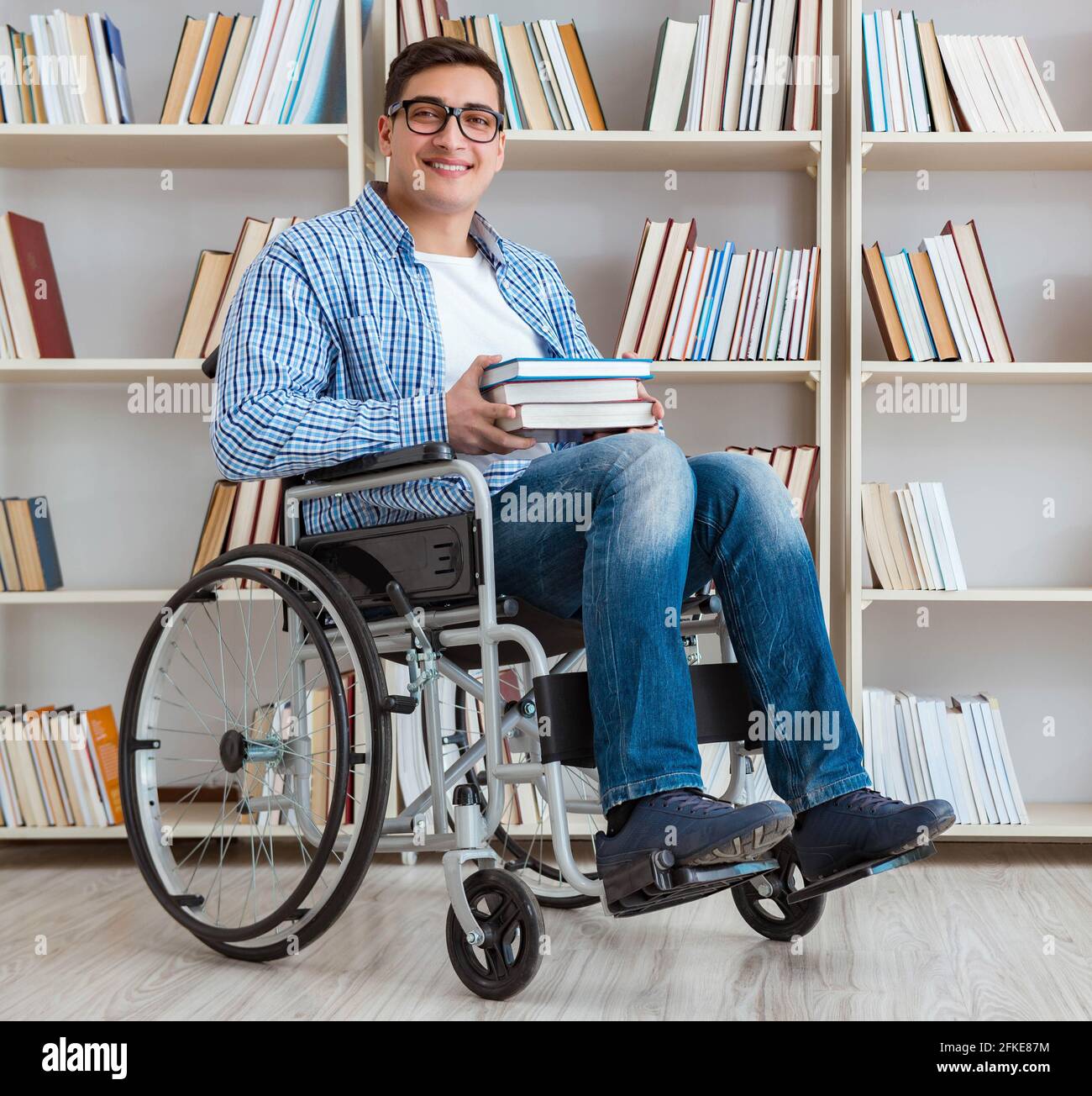 The disabled student studying in the library Stock Photo - Alamy