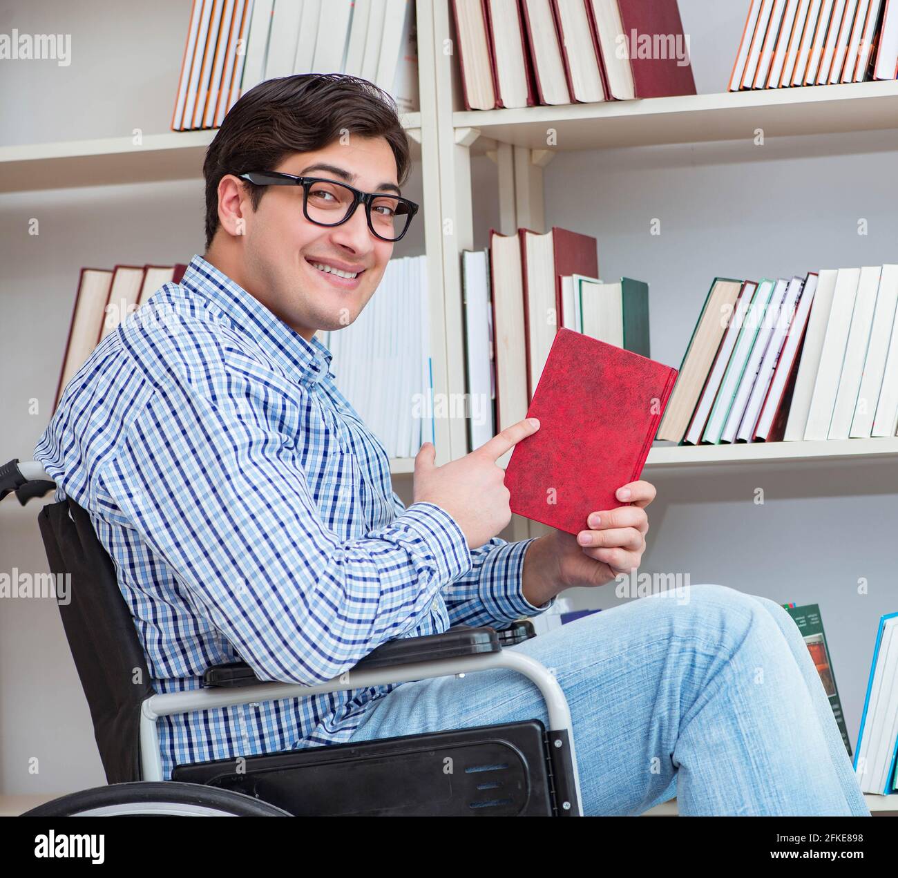 The disabled student studying in the library Stock Photo - Alamy
