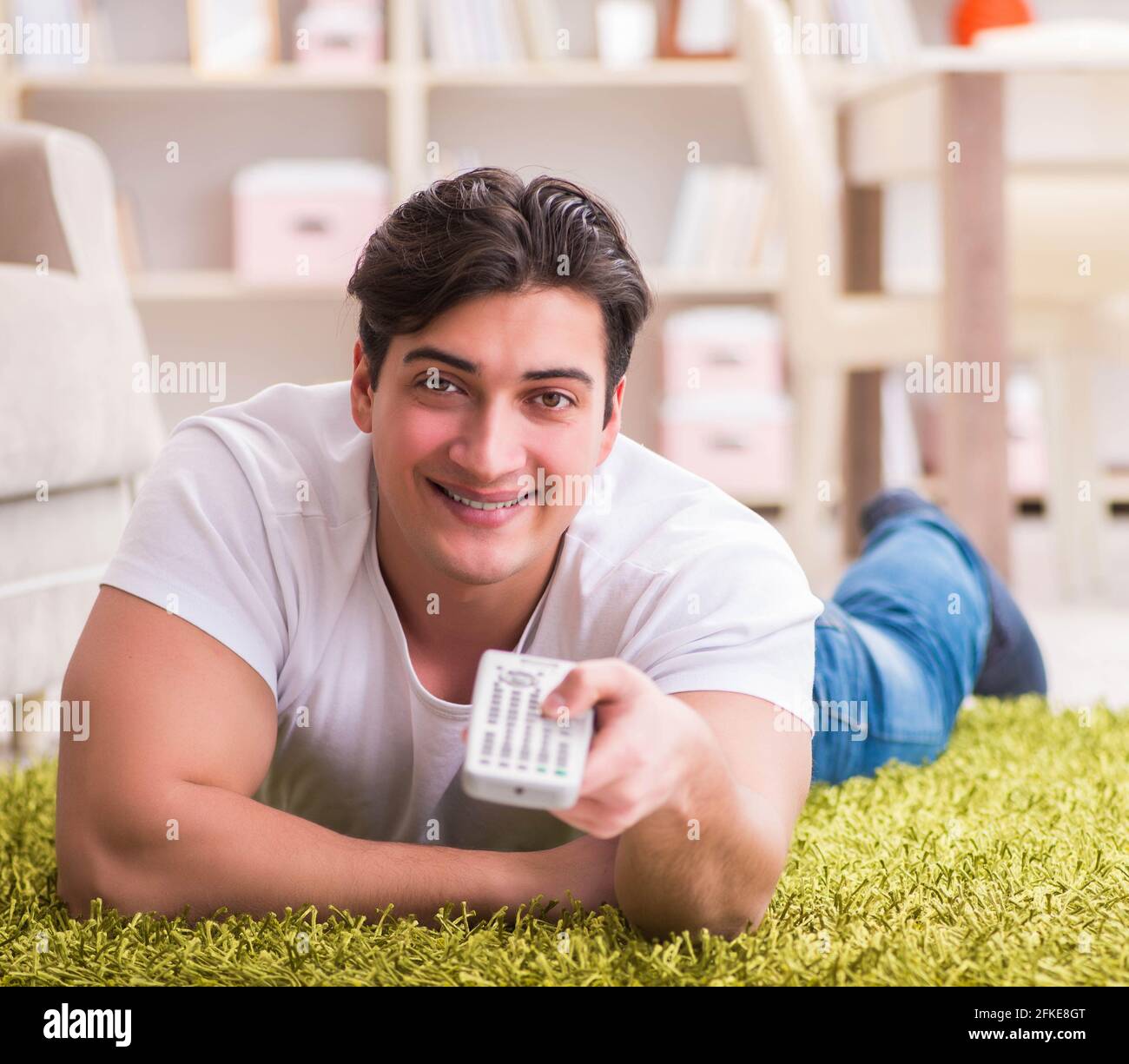 The man watching tv at home on floor Stock Photo - Alamy