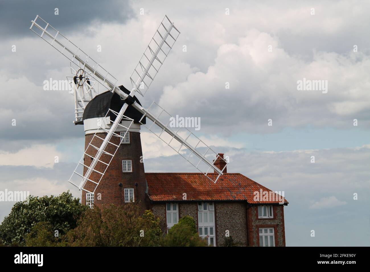 A Traditional Windmill Adjacent to a Brick House Stock Photo - Alamy