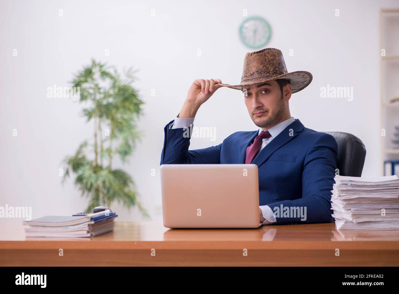 Young cowboy employee working at workplace Stock Photo - Alamy