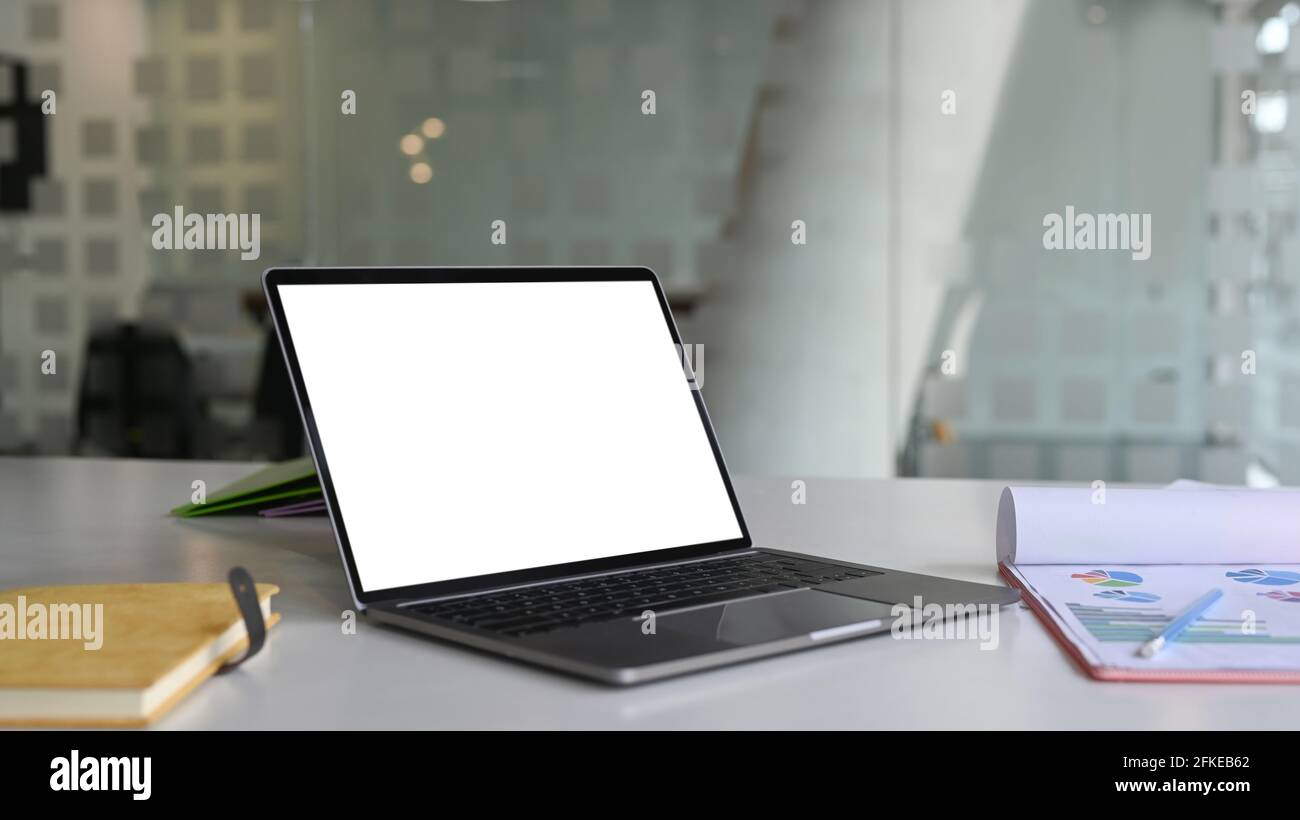 Mock up computer laptop with blank screen, paperwork and notebook on ...