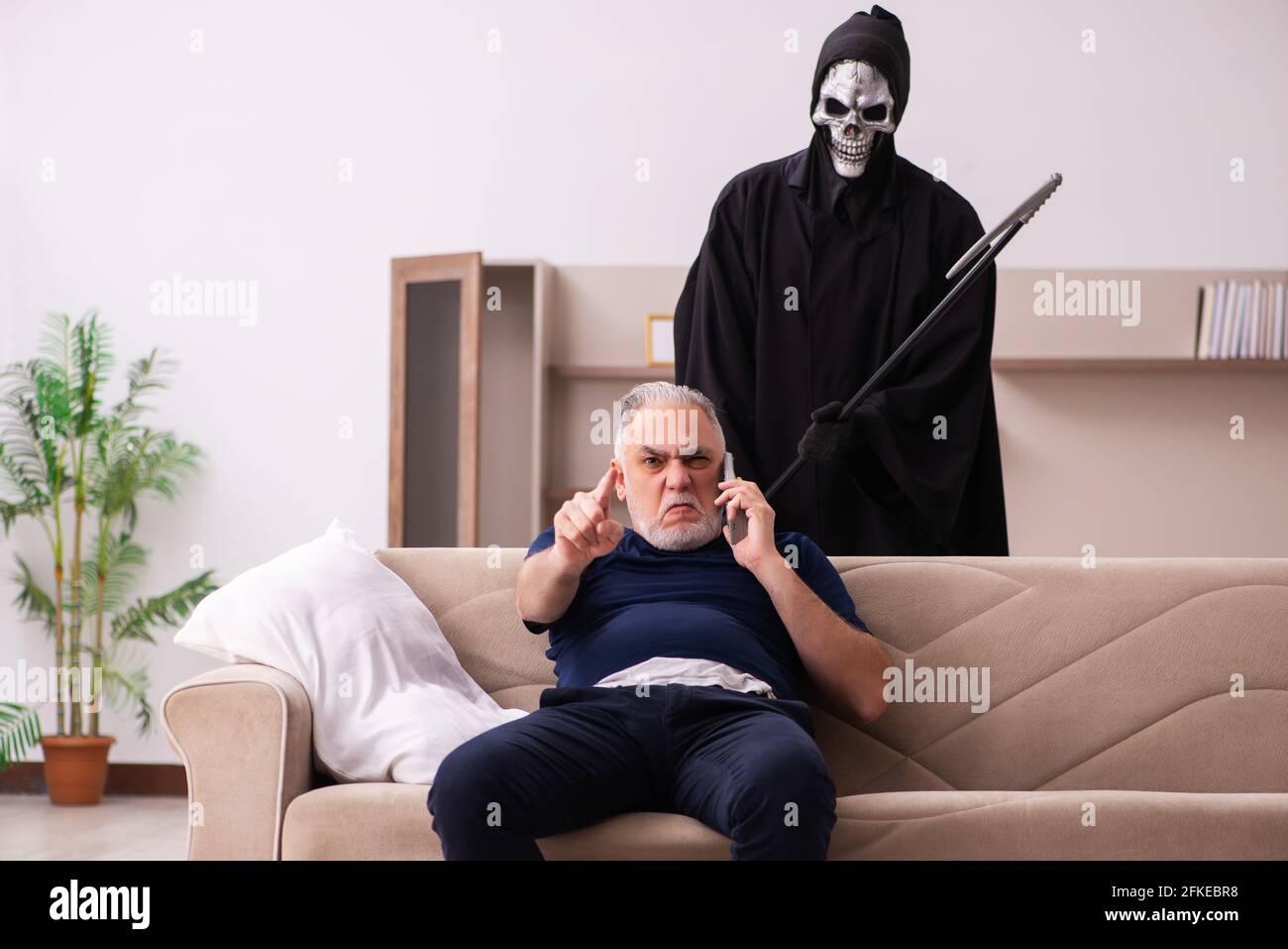 Devil coming to old dying man Stock Photo - Alamy