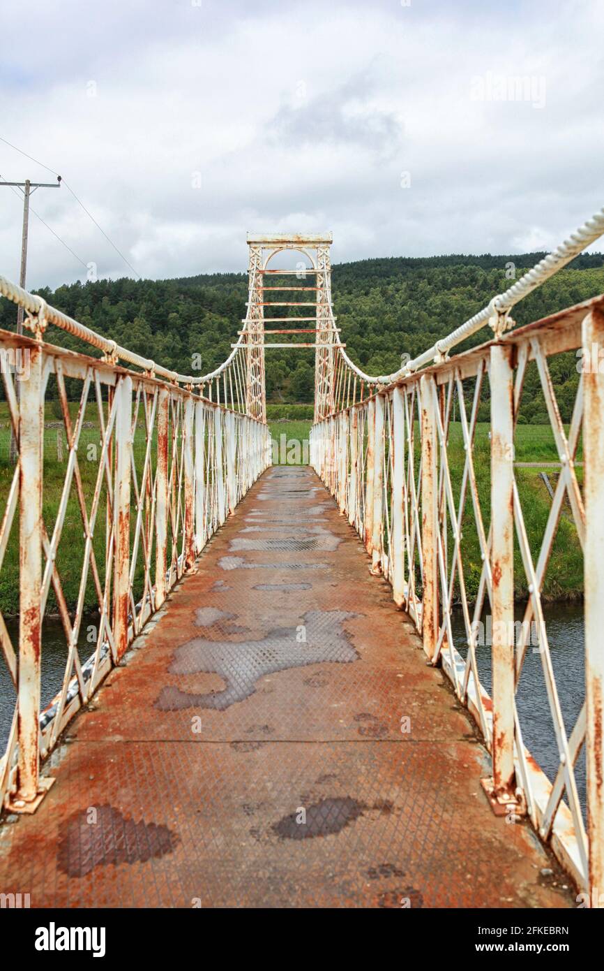 Rusty Victorian suspension bridge of 1892 near Ballater in Scotland ...