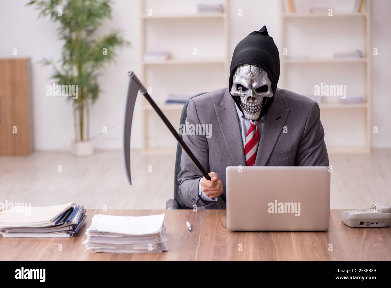 Devil businessman employee working in the office Stock Photo - Alamy