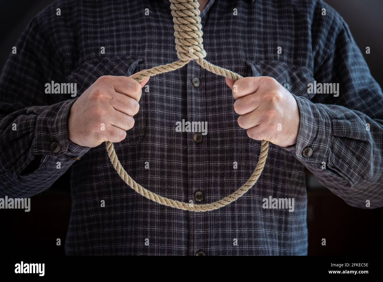 A man holding a noose, close up Stock Photo - Alamy