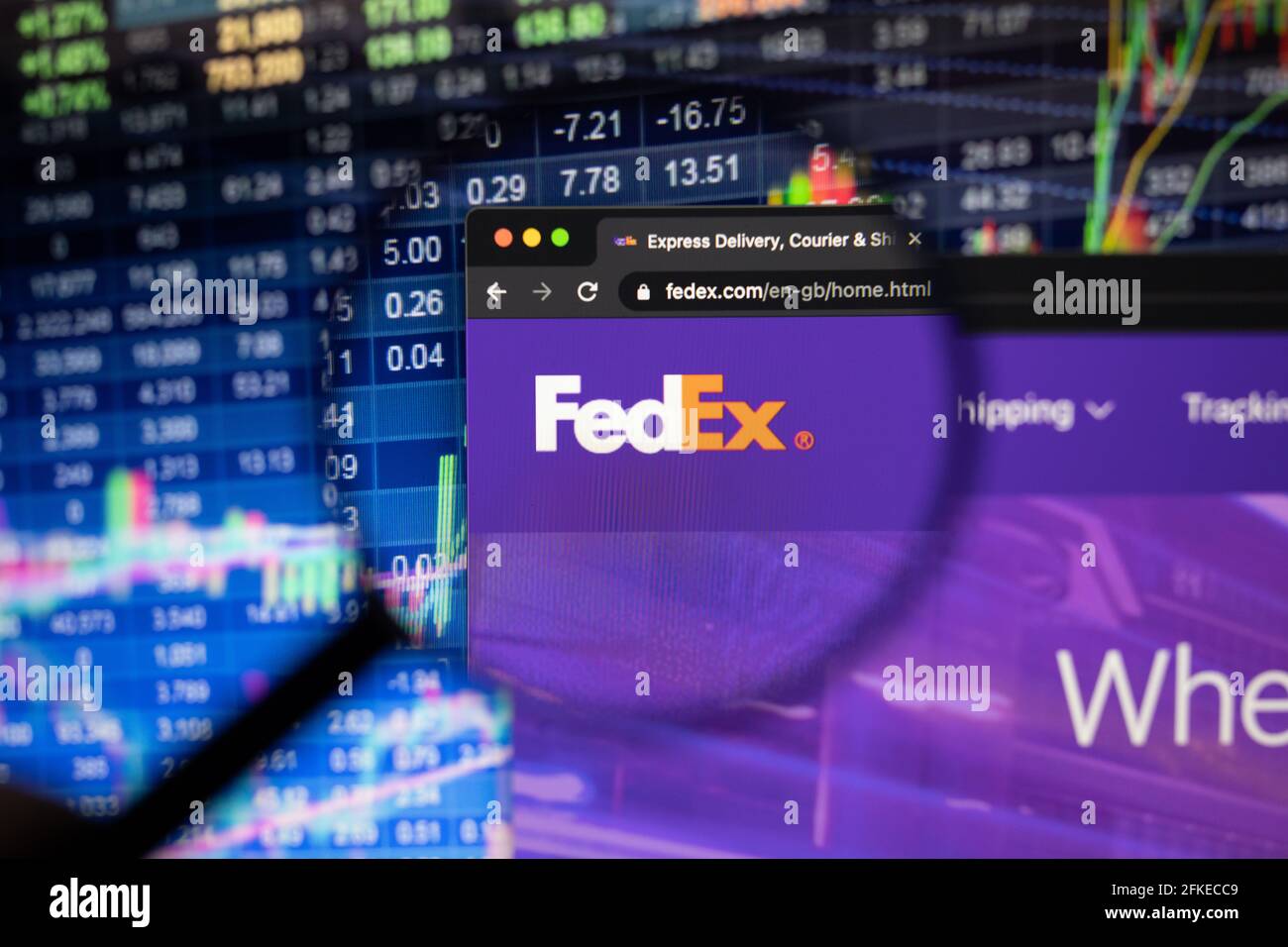 FedEx company logo on a website with blurry stock market developments ...