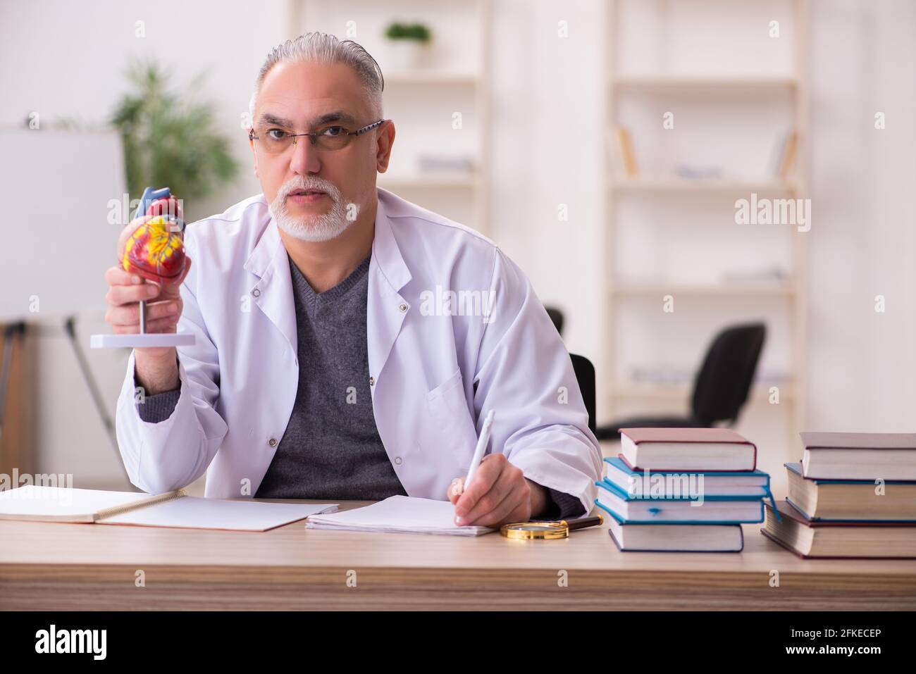 Old doctor cardiologist sitting in the classroom Stock Photo - Alamy