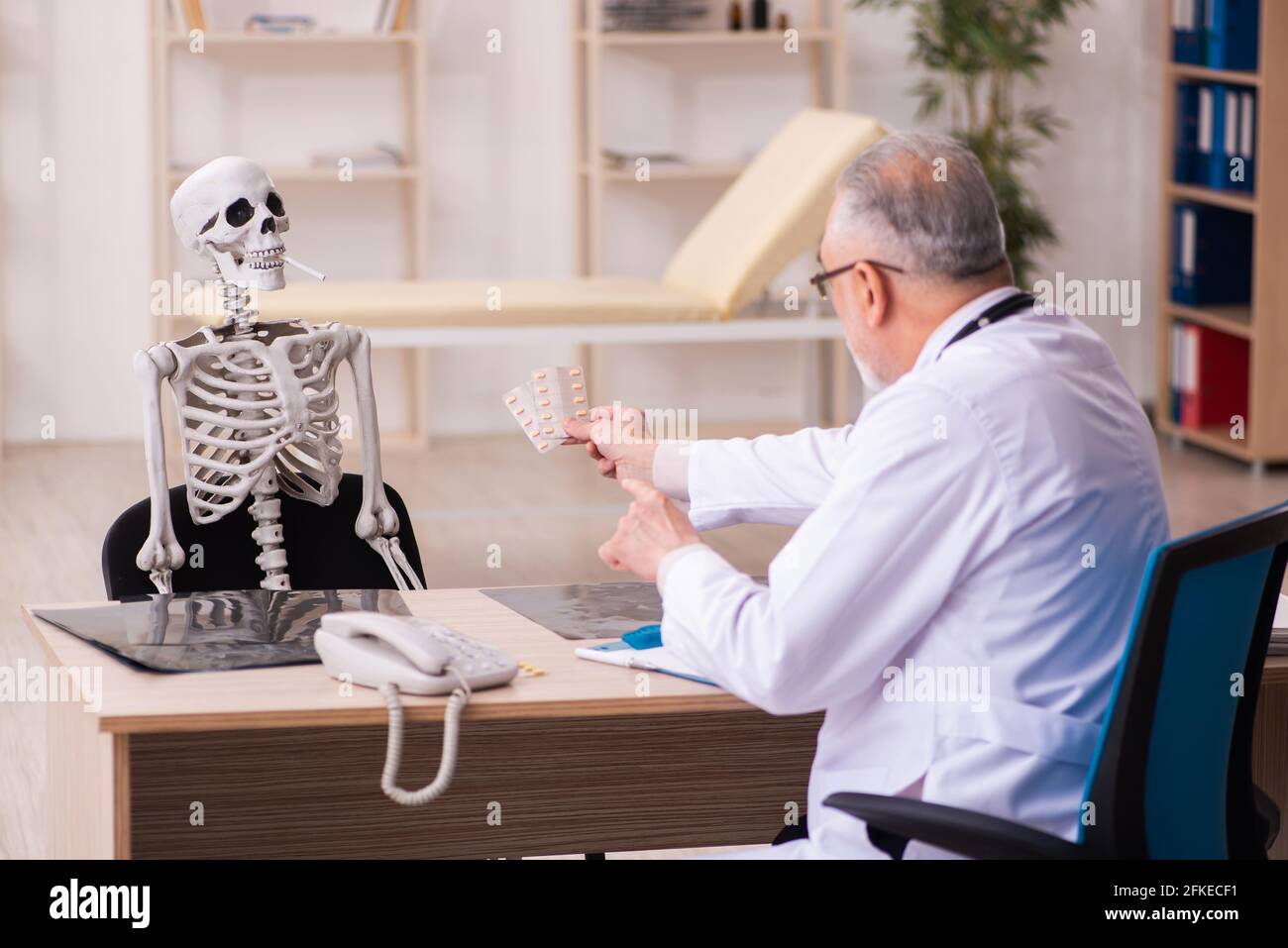 Skeleton cigarette addicted patient visiting old male doctor Stock ...
