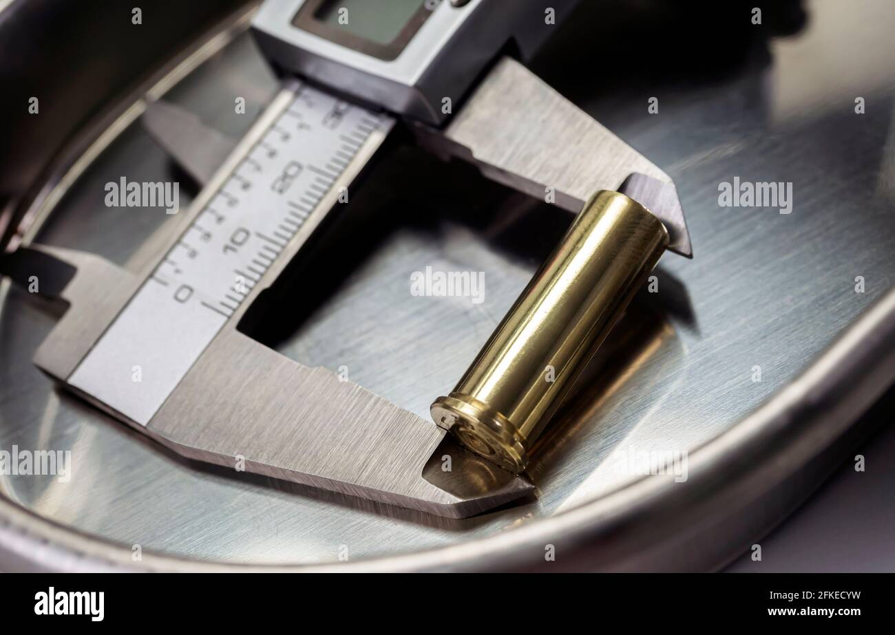 measures bullet caliber in ballistic lab, conceptual image Stock Photo ...