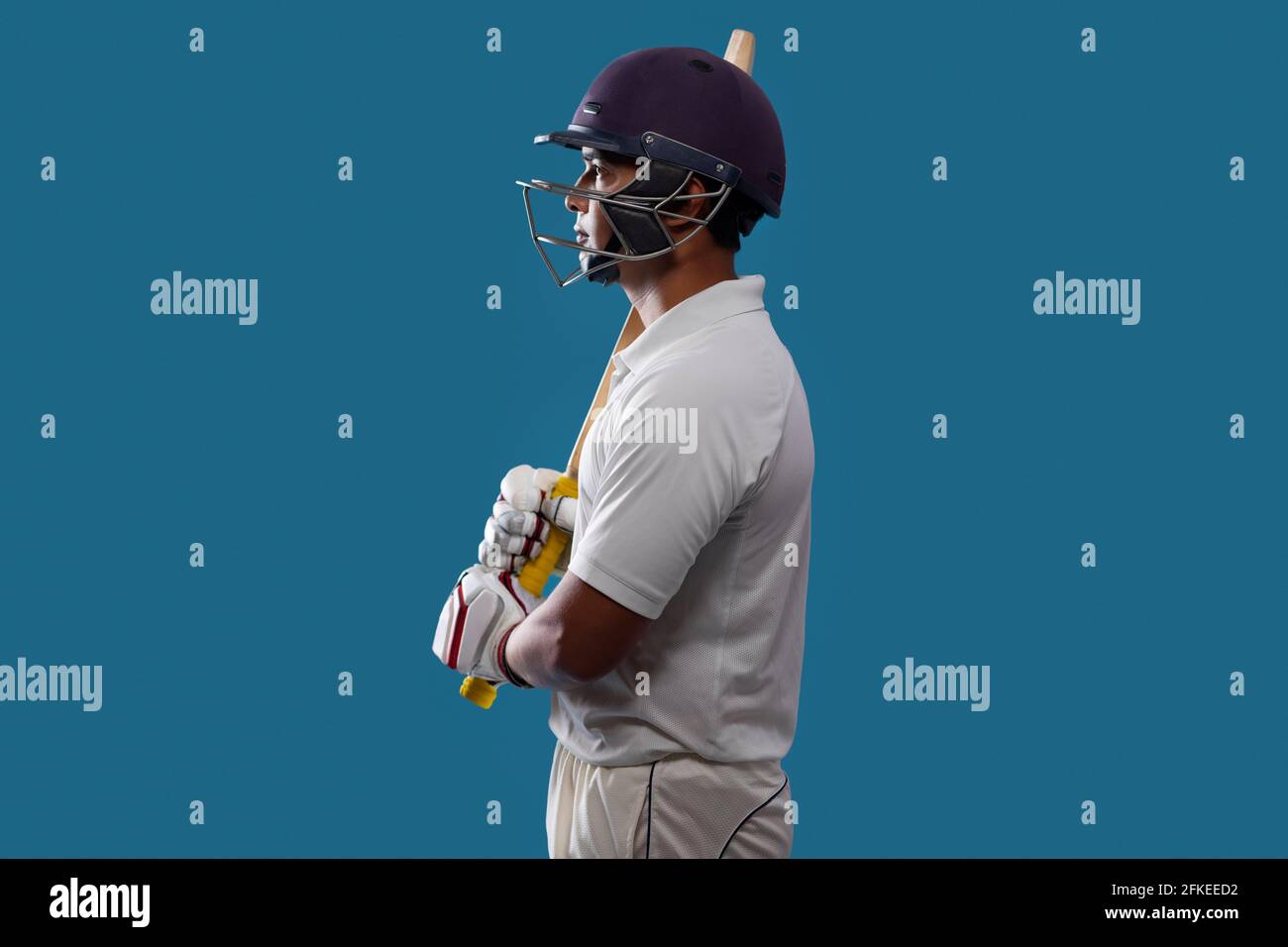 Cricketer holding a bat Stock Photo - Alamy