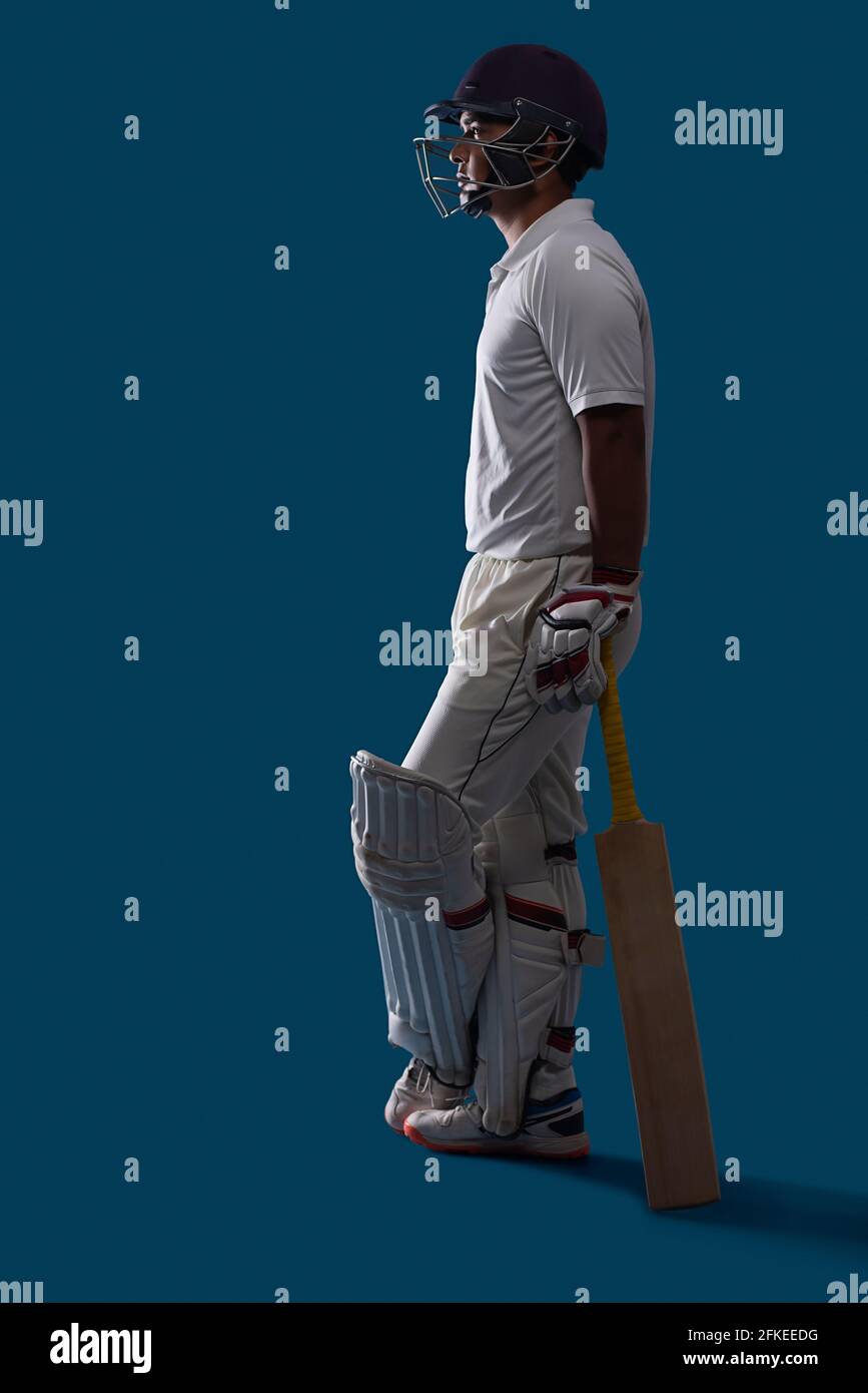 Cricketer holding a bat Stock Photo - Alamy