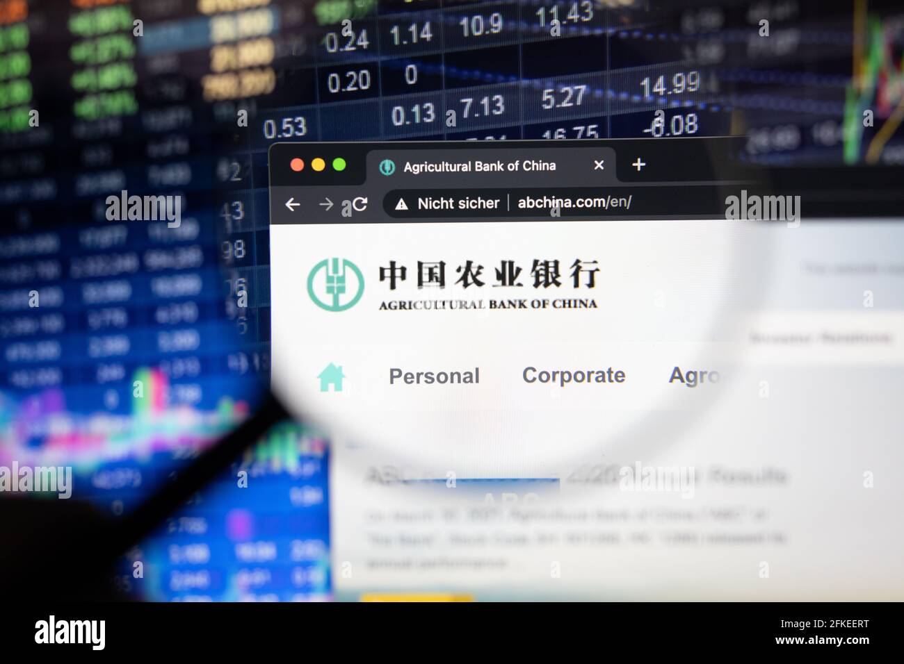 Agricultural Bank of China company logo on a website with blurry stock market developments in ...