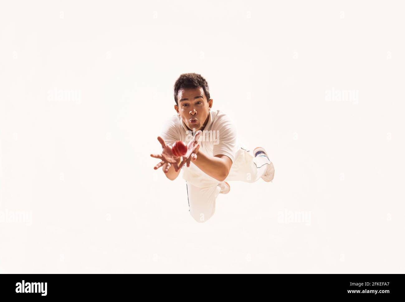 Fielder diving to take a catch Stock Photo - Alamy