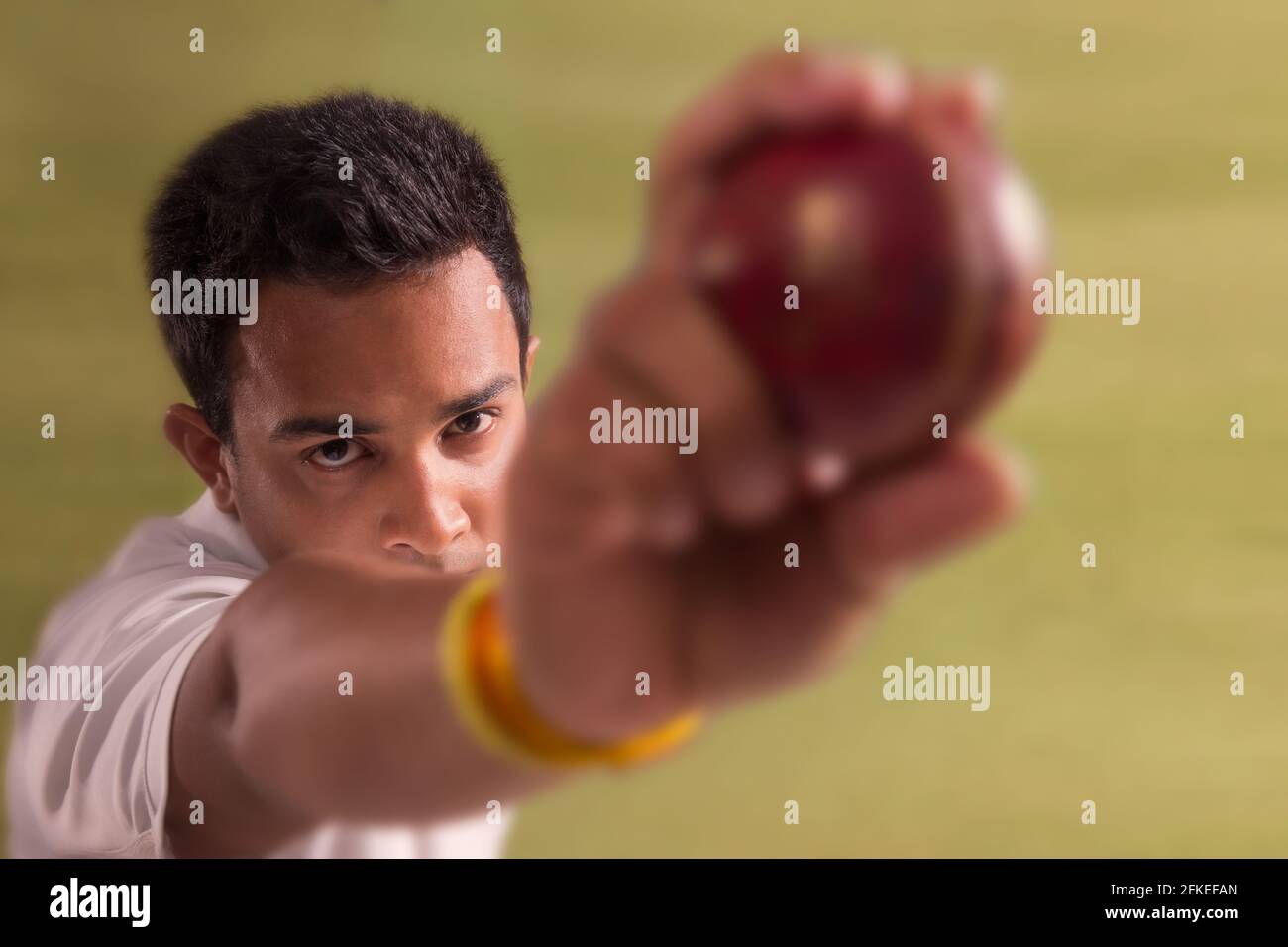 Cricketer, Bowler with a bowl at the field Stock Photo - Alamy