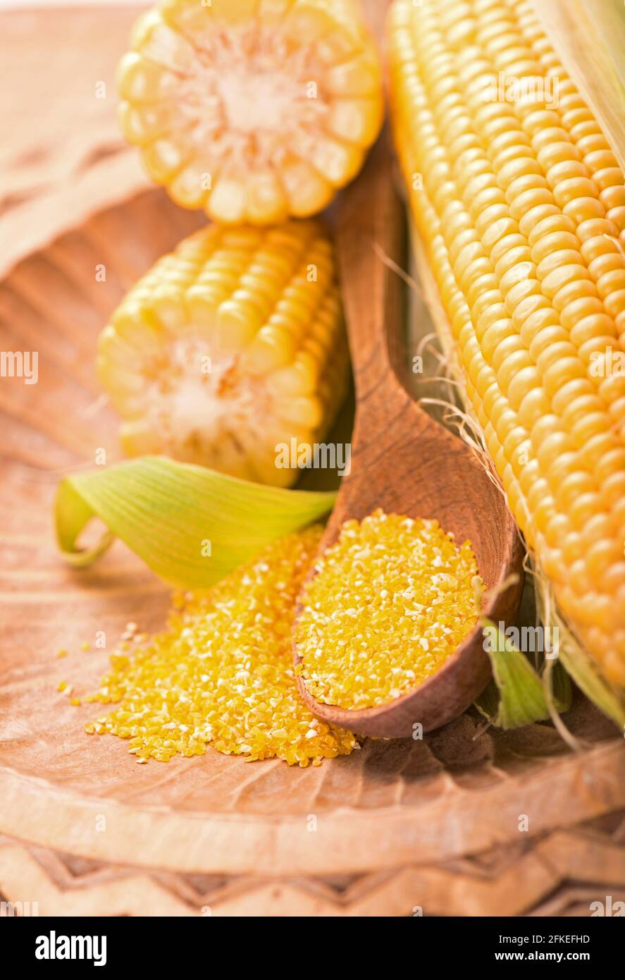 raw corn with green leaves on a white background Stock Photo - Alamy