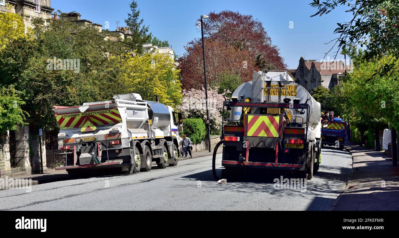 Road maintenance spreading bitumen and gravel chippings for resurfacing ...