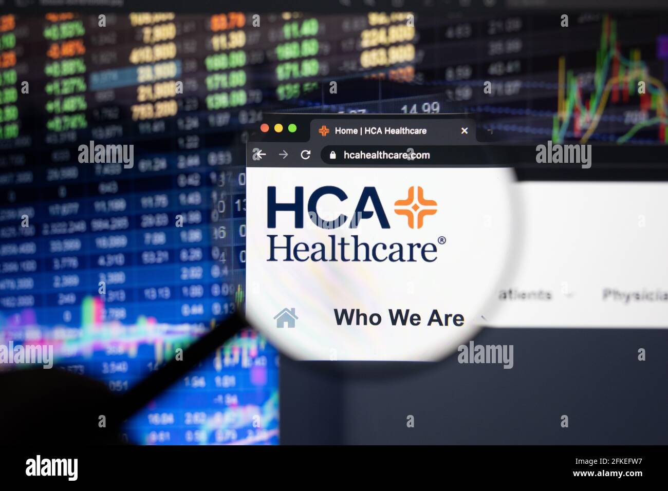 HCA Healthcare company logo on a website with blurry stock market ...