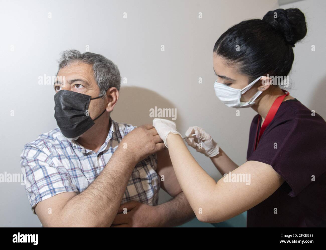 Turkish nurse vaccinates a man against COVID-19 with Pfizer BioNTech ...