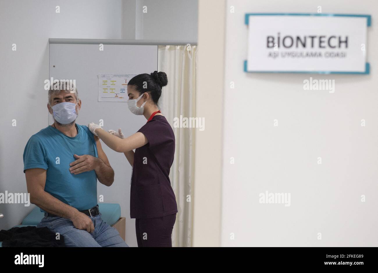 Turkish nurse vaccinates a man against COVID-19 with Pfizer BioNTech ...