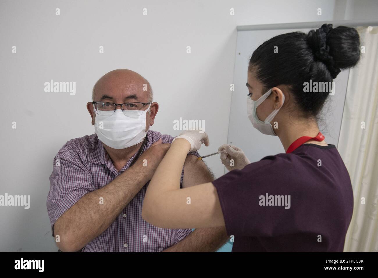 Turkish nurse vaccinates a man against COVID-19 with Pfizer BioNTech ...