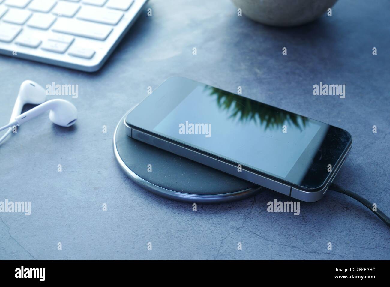 charging Smartphone using Wireless Charging Pad, top view Stock Photo ...