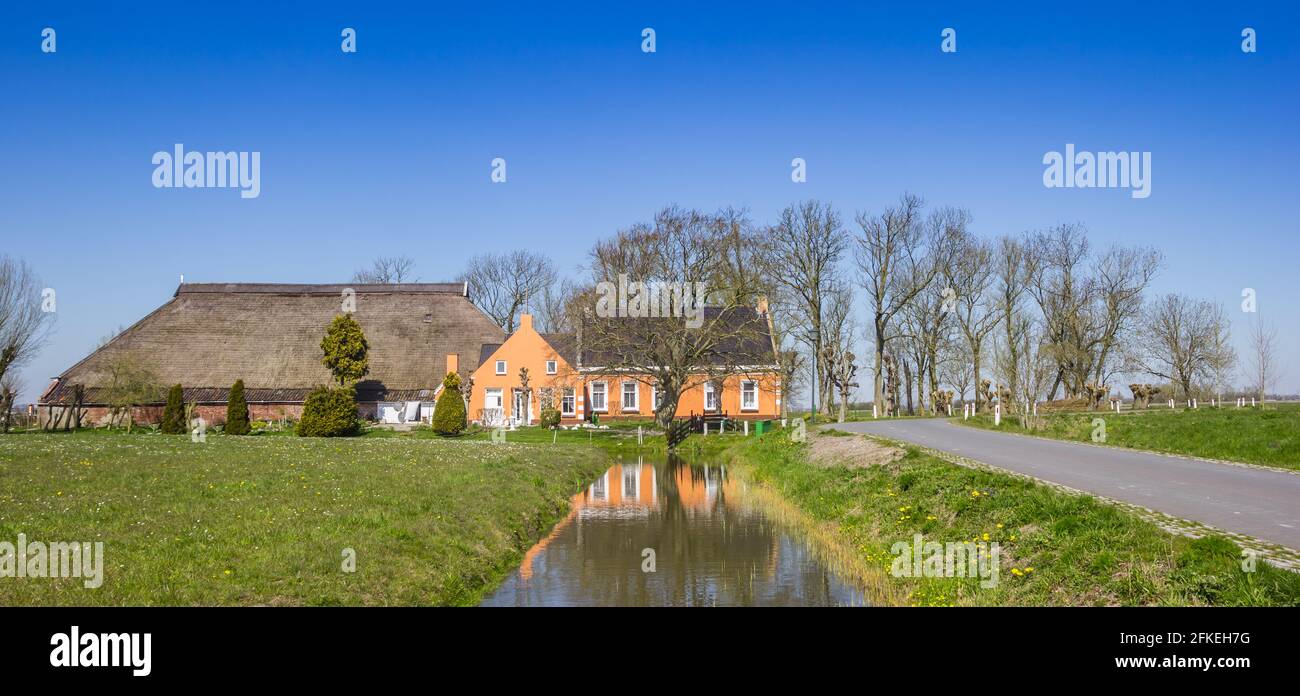 Panorama of a orange farmhouse in the landscape of Groningen ...