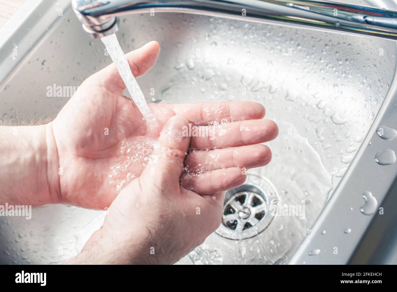 Male Washing His Hands Under Water Stream At A Kitchen Sink Stock Photo ...