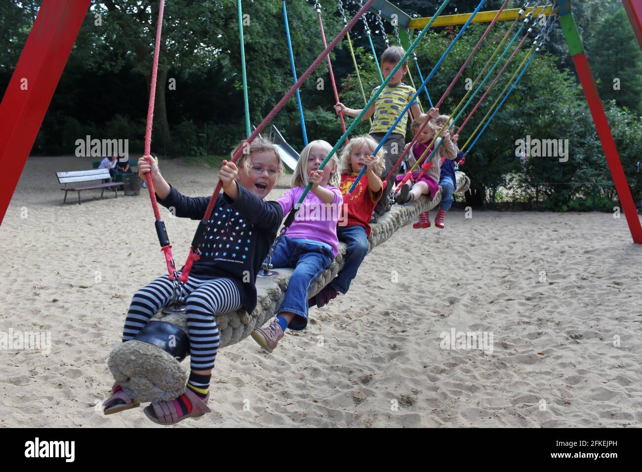 kids swinging on a swing Stock Photo - Alamy