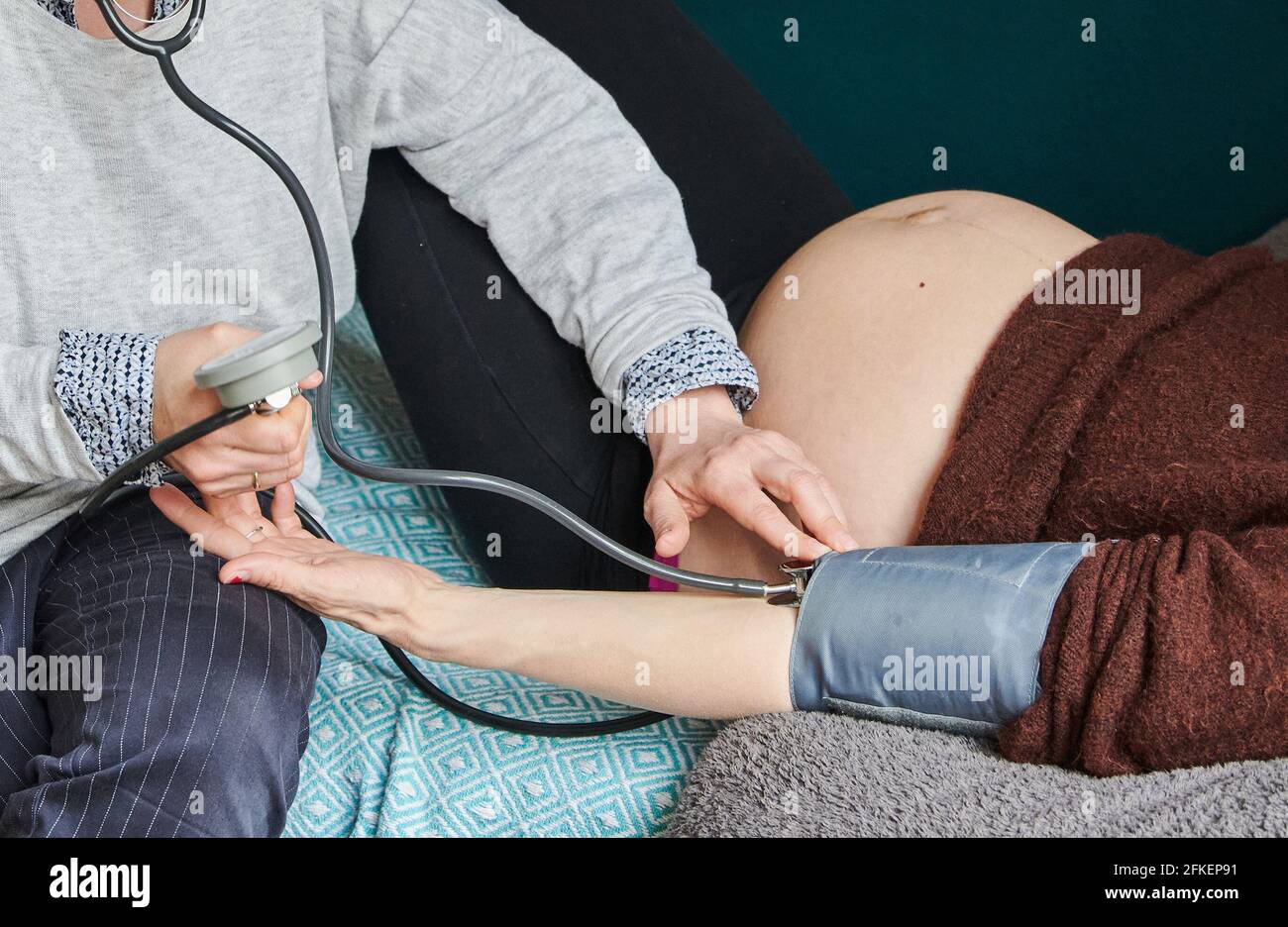 Berlin, Germany. 17th Apr, 2021. A midwife measures the blood pressure ...