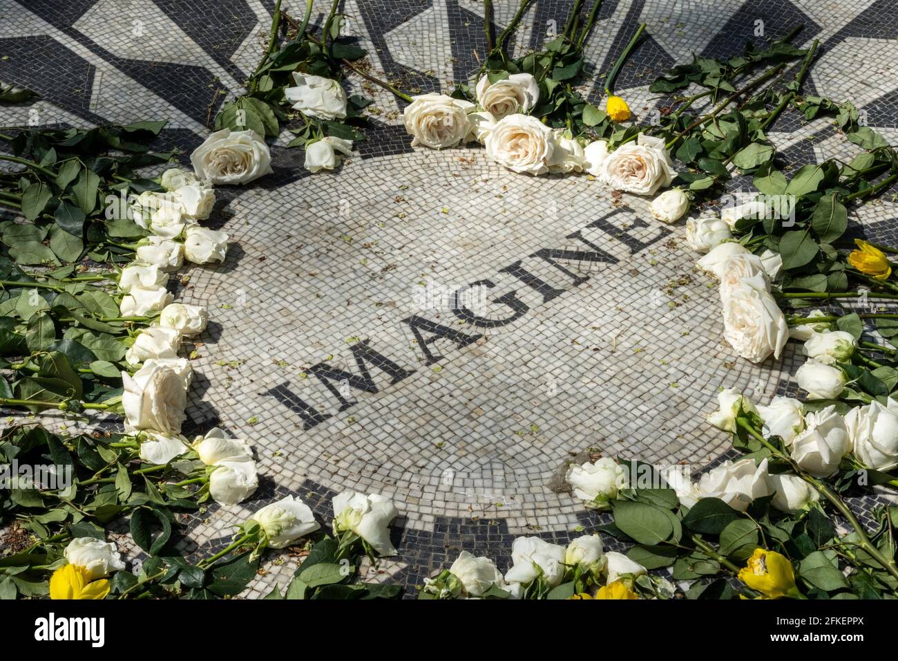 Flowers surround the living memorial mosaic "Imagine" which is a ...