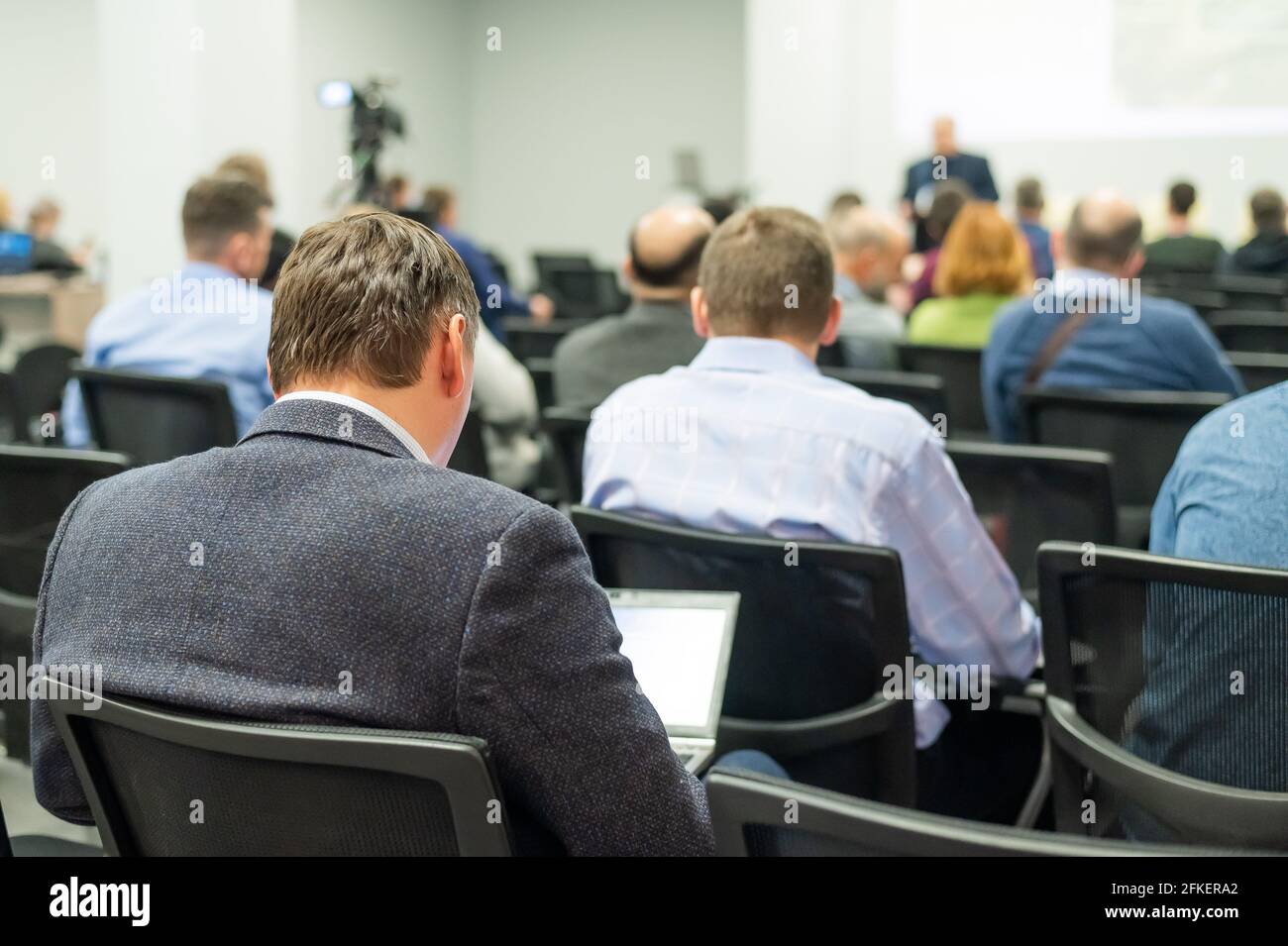 a man leading a discussion in a conference room Stock Photo - Alamy