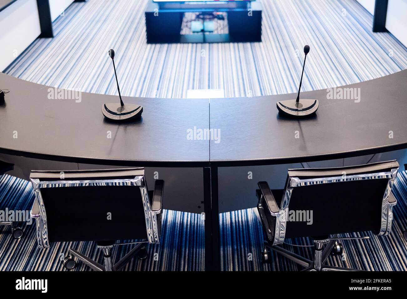 Close-up of microphones in an empty meeting room at a press conference ...