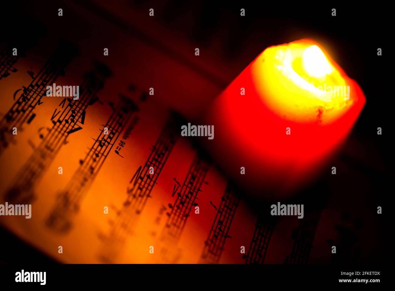 Music Notes Sheet in a Red Candle Light Photo Stock Photo - Alamy